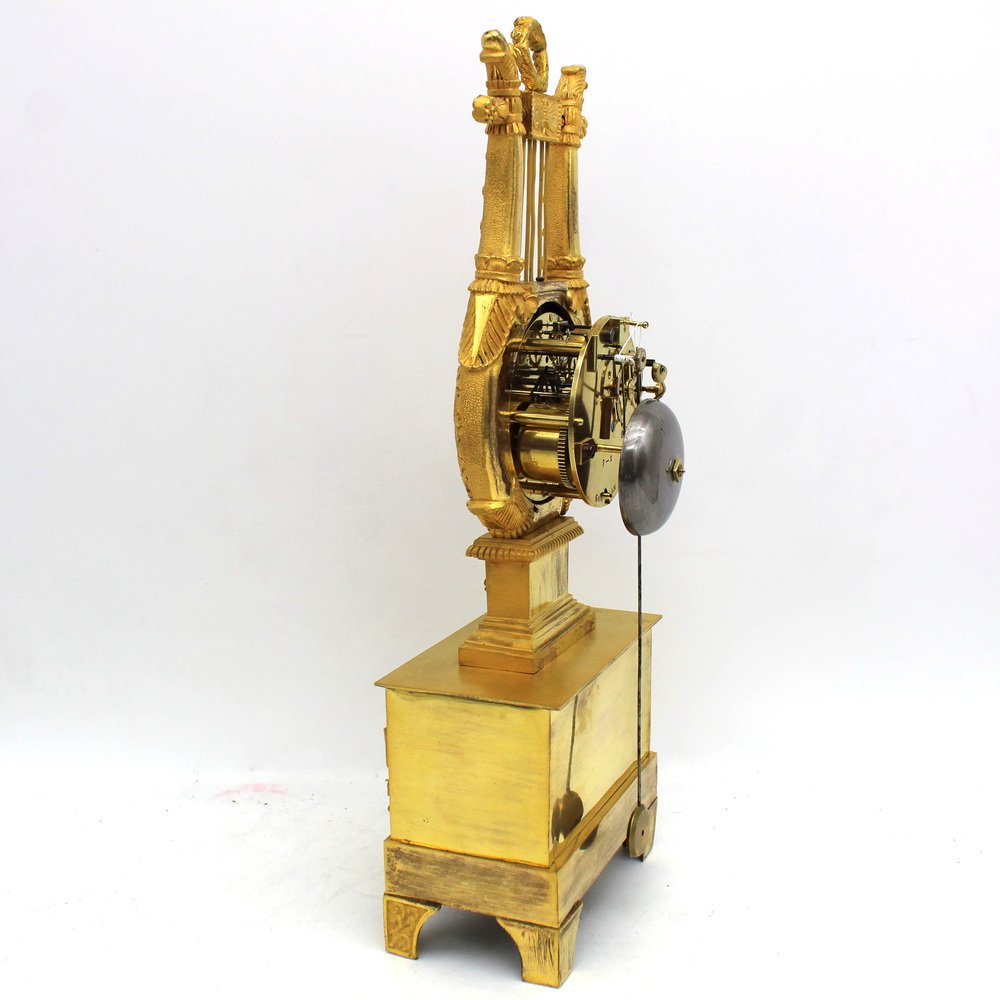 19th Century Empire Gilt Bronze Lira Pendulum Clock for sale at Pamono