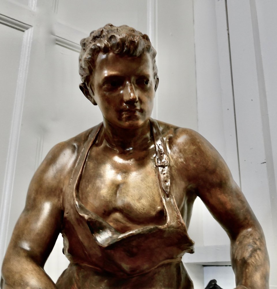 Large Plaster Figurine of the Seated Blacksmith, 1920s for sale at Pamono