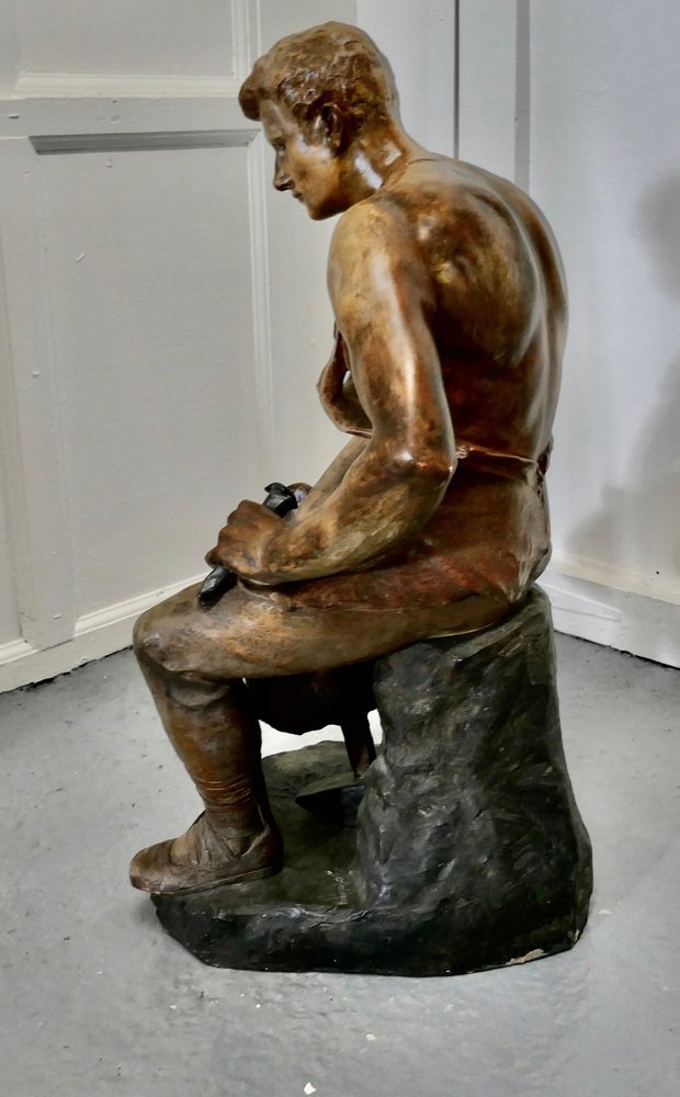 Large Plaster Figurine of the Seated Blacksmith, 1920s for sale at Pamono