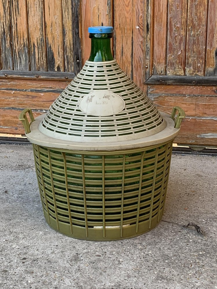 Mid-Century Glass Demijohn in Plastic Basket for sale at Pamono